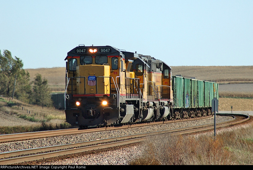 UP 9047, GE Dash-8 40C, ex C&NW 8526, leads a westbound ballast train